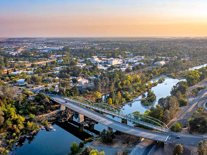Oroville's golden hour view showcases the perfect marriage of nature and small-town charm. That bridge isn't just connecting banks—it's connecting generations of California history.
