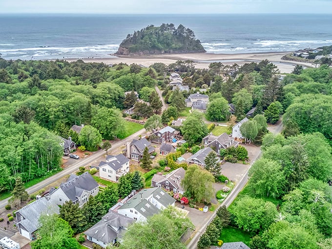 The village unfolds like a storybook beneath towering evergreens, with Proposal Rock anchoring this coastal paradise where time seems to slow down.
