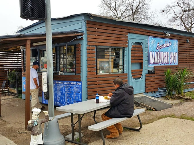 The blue sign beckons like a neon oasis in the desert of chain restaurants. Sparkle's wooden exterior promises authenticity that no focus group could ever design.