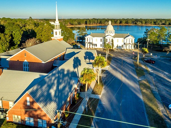 Lake DeFuniak shimmers like nature's mirror, reflecting historic buildings and towering church spires in this perfectly circular spring-fed wonder.
