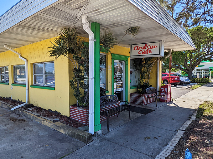 The sunshine-yellow exterior of Tin Can Cafe stands out like a tropical bird in Clearwater, complete with those inviting benches that practically whisper, "Stay awhile."