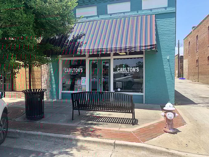 The mint-green facade with its classic striped awning isn't trying to impress anyone—it doesn't need to. The food does all the talking.