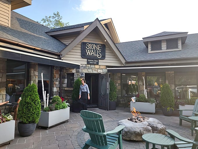 The entrance beckons with Adirondack chairs and a crackling fire pit—nature's perfect waiting room for what lies beyond those wooden doors.