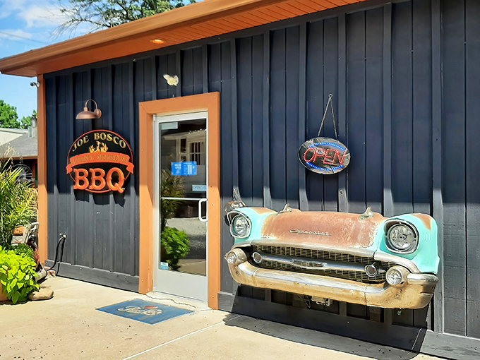 The navy blue exterior with that vintage car front mounted on the wall isn't just decoration—it's a promise that what awaits inside is classic Americana at its most delicious.