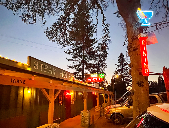 That neon glow isn't just a sign—it's a beacon of hope for hungry travelers seeking carnivorous salvation in the Sierra foothills.