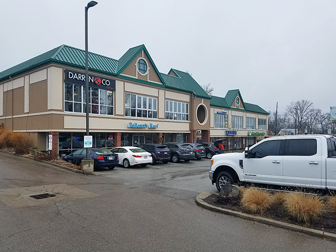 The bright blue sign of Pelican's Reef stands out like a maritime beacon, promising seafood salvation in suburban Cincinnati's unexpected strip mall setting.