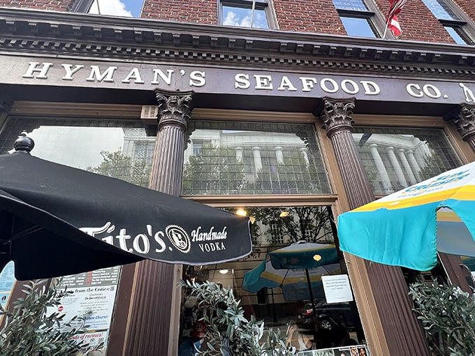 The historic brick façade of Hyman's Seafood stands proudly on Meeting Street, flags waving like a maritime welcome committee for hungry visitors.