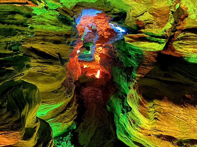 Nature's light show on full display! The vibrant illumination transforms these ancient sandstone formations into a psychedelic underground dreamscape that feels straight out of a sci-fi film.