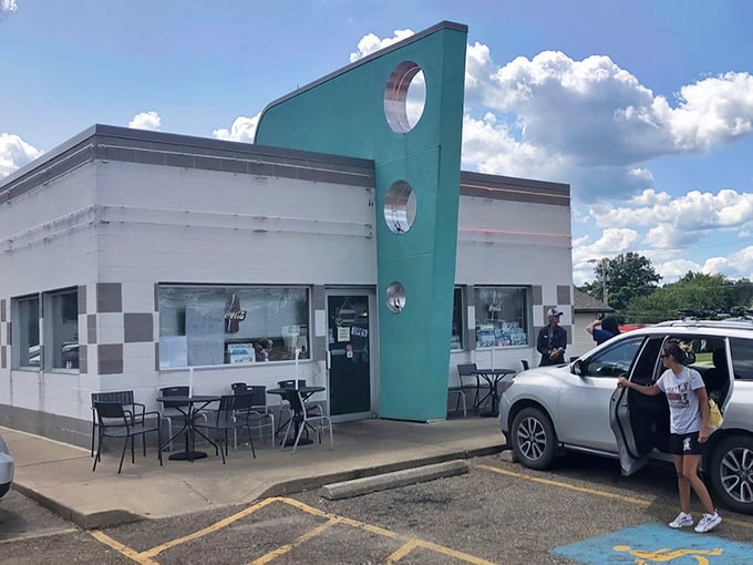 The turquoise fin-like accent wall isn't just architectural flair—it's a time machine disguised as a diner. Welcome to retro paradise.