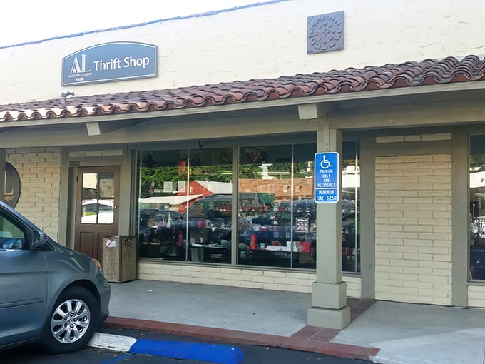 The unassuming storefront of Assistance League of Tustin Thrift Shop – where treasure hunting begins beneath that classic Spanish-style roof.