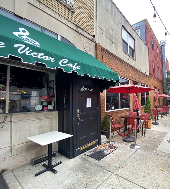 The iconic green awnings of Victor Café stand out on this South Philly street corner, promising musical and culinary delights within those brick walls.