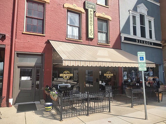 The charming brick façade of Café Paradiso brings a touch of European elegance to downtown Urbana, complete with inviting outdoor seating perfect for people-watching.