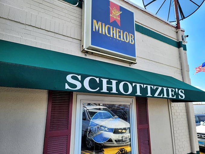 The unassuming exterior of Schottzie's, with its classic green awning, proves once again that culinary adventures often hide behind the most modest facades.