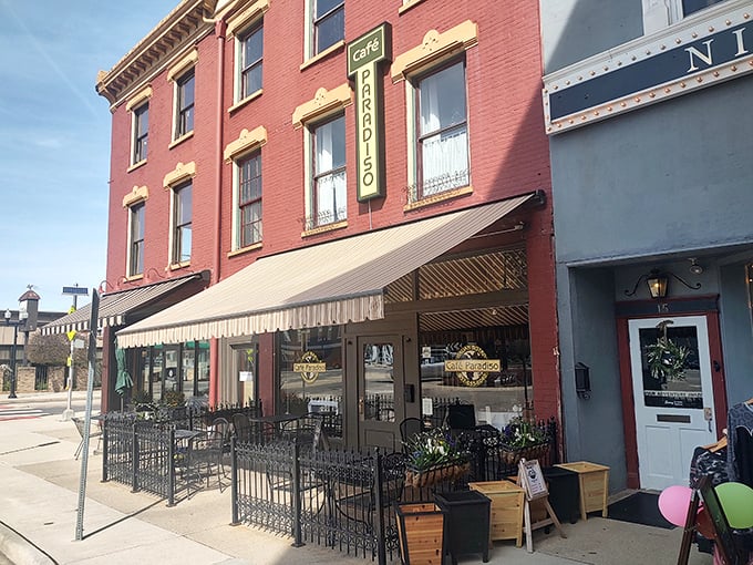 The charming brick façade of Café Paradiso brings a touch of European elegance to downtown Urbana, complete with inviting outdoor seating perfect for people-watching.
