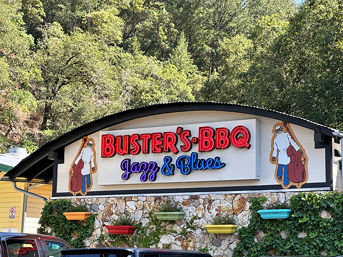 Stone walls draped with ivy frame the bold red "BUSTER'S BBQ" sign – a siren call to barbecue pilgrims in wine country's unexpected smoke sanctuary.