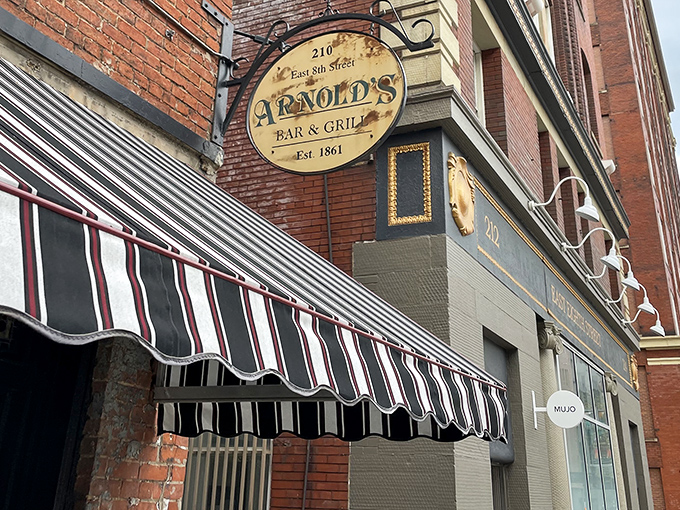 That iconic striped awning and vintage sign aren't trying to be retro-cool—they're the real deal, standing sentinel on Cincinnati's East 8th Street since long before "vintage" was trendy.