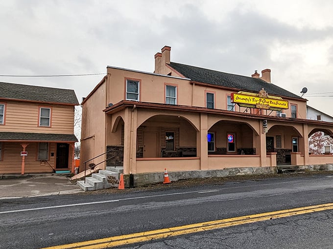 With its peach-colored walls and flame-kissed sign, Grumpy’s stands as a true barbecue beacon—no frills, just smoky goodness that speaks for itself.