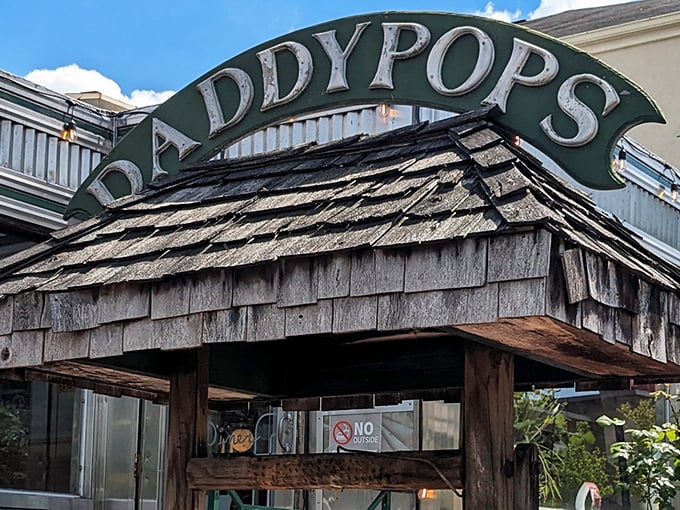 The iconic wooden-shingled entrance to Daddypops stands like a time machine disguised as a diner, beckoning hungry travelers with its vintage charm.