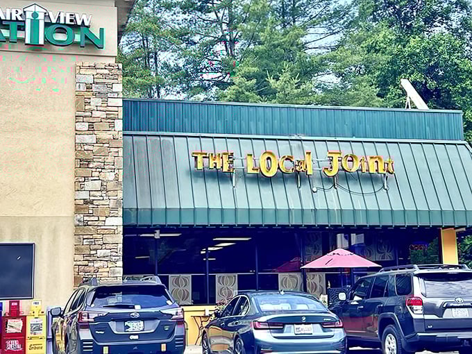 The Local Joint's exterior welcomes you with cheerful yellow accents and colorful umbrellas – like a culinary lighthouse beckoning hungry travelers to safe harbor.