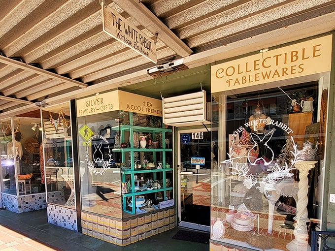 The storefront beckons like a vintage postcard come to life, with its charming signage promising treasures organized by category—silver, tea, and collectible tablewares await!