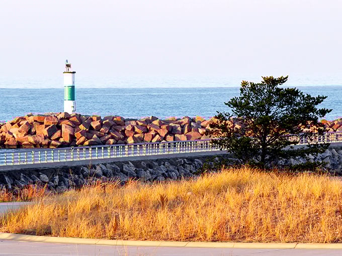 The breakwater pier stretches toward the horizon like a concrete invitation to adventure, complete with a lighthouse that practically winks at you.