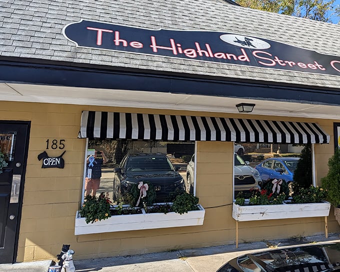 The yellow facade and classic black-and-white striped awning of Highland Street Cafe isn't shouting for attention—it's confidently whispering "breakfast paradise awaits."