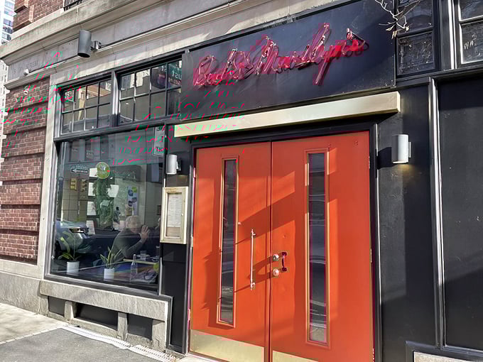 Those iconic red doors aren't just an entrance – they're a portal to comfort food nirvana in Philadelphia's bustling Midtown Village.