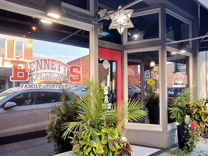 Bennett's welcoming storefront beckons with its distinctive red signage and lush greenery—like a friendly neighbor inviting you over for the good stuff.