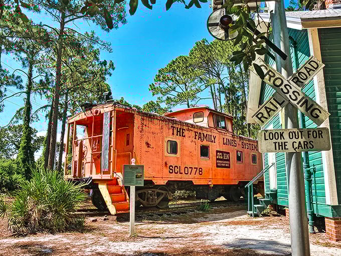 The bright orange Seaboard Air Line Railroad caboose stands out like a traffic cone at a black-tie dinner, offering visitors a glimpse into Florida's railroad history.