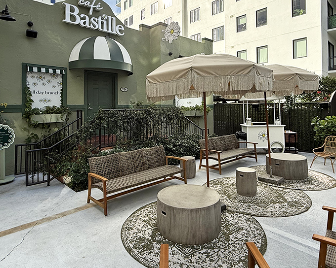 Café Bastille's charming exterior welcomes you with Parisian flair and fringe-adorned umbrellas—like a French postcard come to life in Fort Lauderdale.
