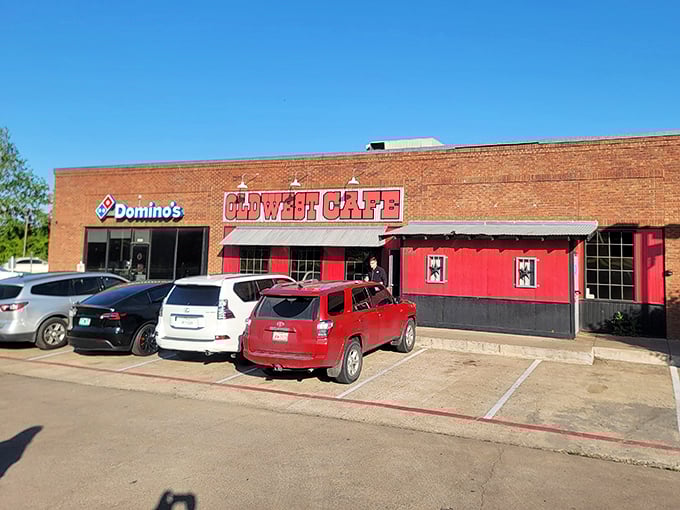 The brick facade and bold red signage of Old West Cafe stands as a beacon of breakfast promise in Grapevine, no fancy frills needed.