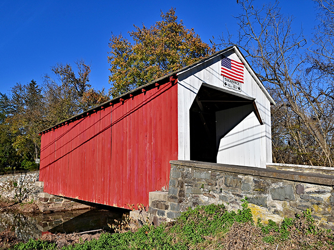 Sunlight plays across the vibrant red siding, creating a postcard-perfect scene that's been stopping photographers in their tracks for generations.