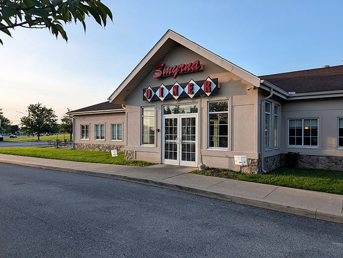 The classic red "DINER" sign beckons like a lighthouse for the hungry. Smyrna Diner's welcoming exterior promises comfort food salvation ahead.