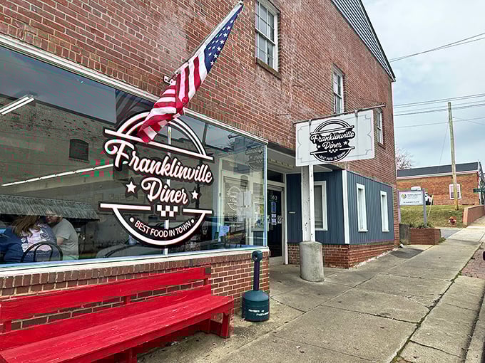 The American flag stands proud outside this brick-faced treasure – Franklinville Diner promises "Best Food in Town" and delivers on that patriotic pledge.
