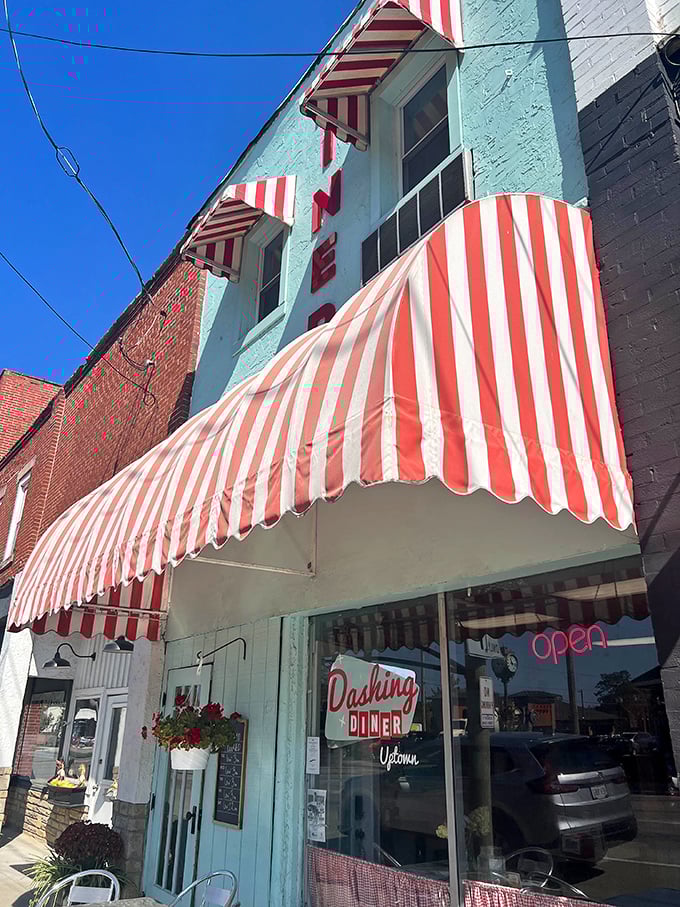 That mint-green facade with candy-striped awnings isn't just eye-catching—it's a time machine disguised as a diner in downtown Johnstown.
