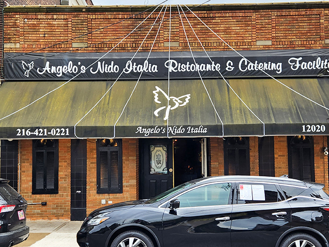 The unassuming brick exterior of Angelo's Nido Italia beckons like an old friend, promising culinary treasures behind its classic awning and modest façade.