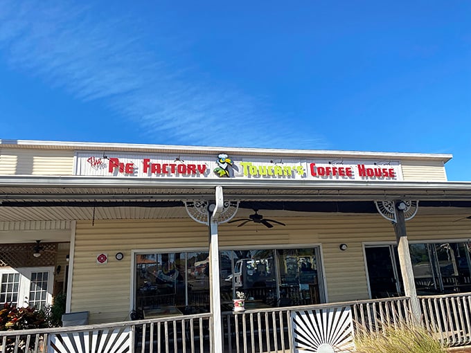 The Pie Factory's cheerful exterior beckons like an old friend inviting you over for dessert. That porch practically whispers, "Stay awhile, calories don't count here."