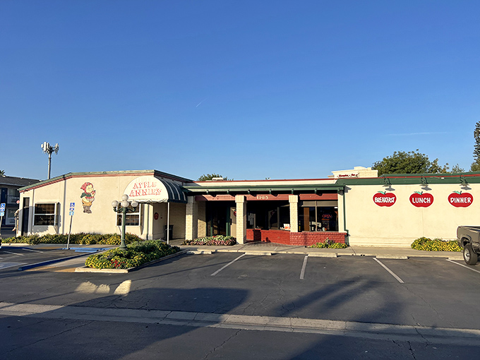 The iconic white awning of Apple Annie's welcomes hungry travelers like a culinary lighthouse in Tulare's sea of agriculture. Those vintage street lamps aren't just for show.