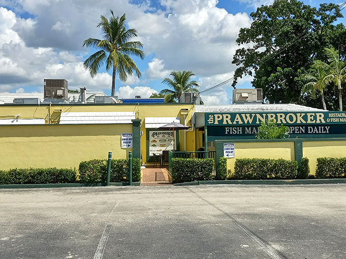 The yellow walls and swaying palms of The Prawnbroker stand like a cheerful beacon for seafood lovers. Florida architecture at its most honest – unpretentious yet promising. 