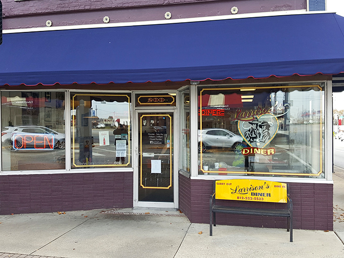 The purple storefront with royal blue awning isn't just a diner—it's a time machine disguised as Larrison's, waiting to transport you to breakfast nirvana.