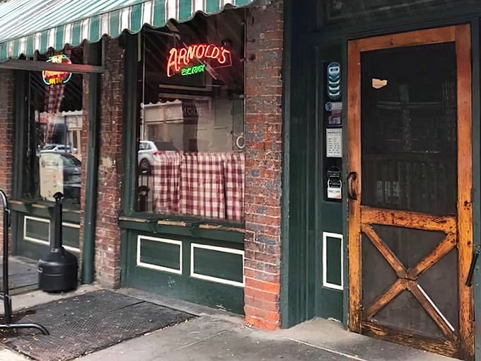 The wooden door with its X-frame design isn't just an entrance – it's a time portal to Cincinnati's most cherished dining institution.