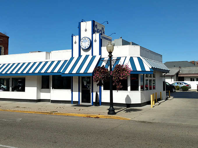 That iconic blue and white striped awning isn't just eye-catching—it's a time portal to when diners were the heart of American towns.
