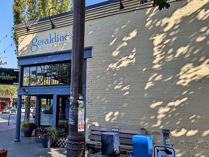 The cream-colored exterior with bright blue trim isn't just inviting—it's practically waving you in for breakfast bliss at Geraldine's Counter.
