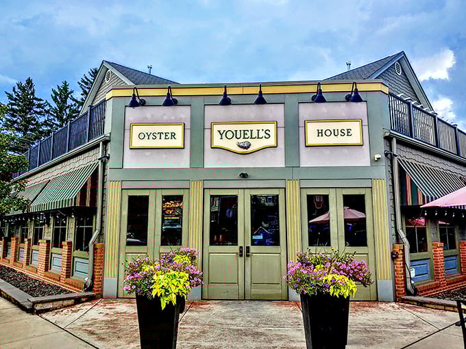 Youell's Oyster House stands like a mint-green beacon of seafood salvation in Allentown, welcoming hungry pilgrims with its classic awnings and vibrant flower displays.