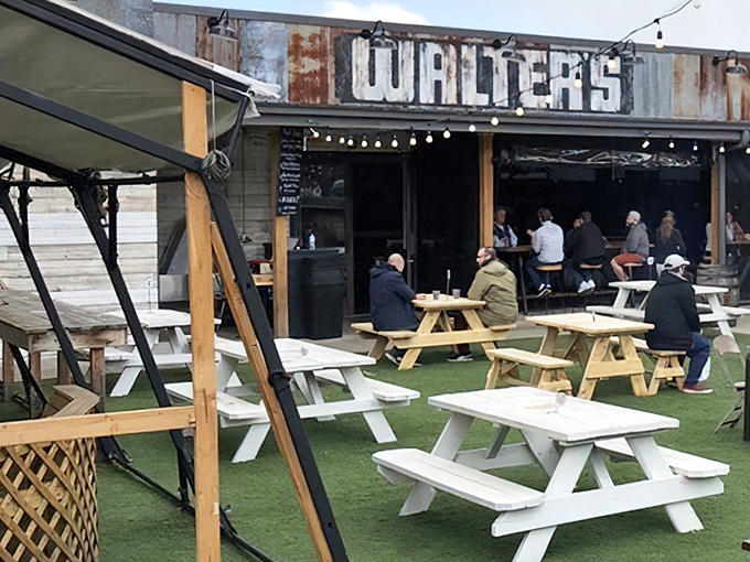 The outdoor dining area at Walter's combines rustic charm with Pittsburgh practicality—string lights overhead turn ordinary picnic tables into the perfect spot for carnivorous communion.