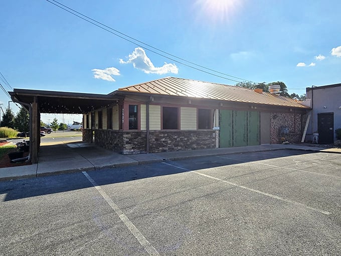 Bathed in golden sunlight, this side view reveals the restaurant's stone foundation – solid as the BBQ principles practiced inside.