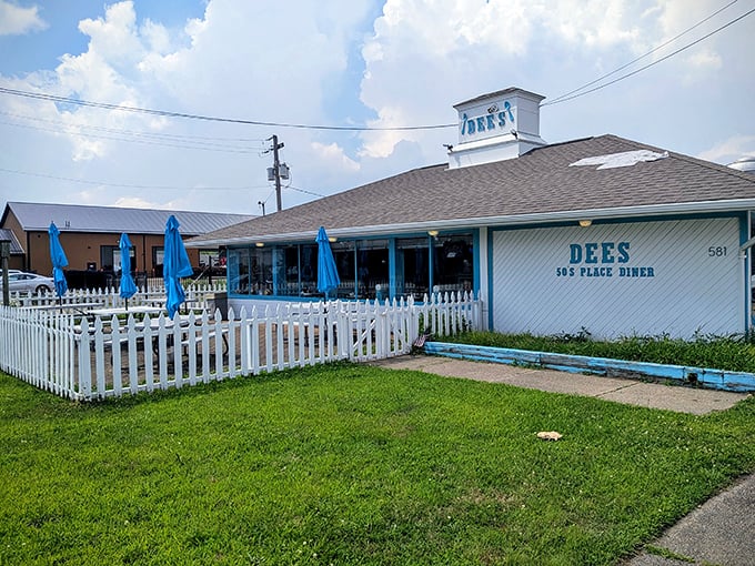 The classic white picket fence surrounding Dee's 50's Place isn't just charming—it's practically a time portal to when dinner conversations didn't involve checking your phone.