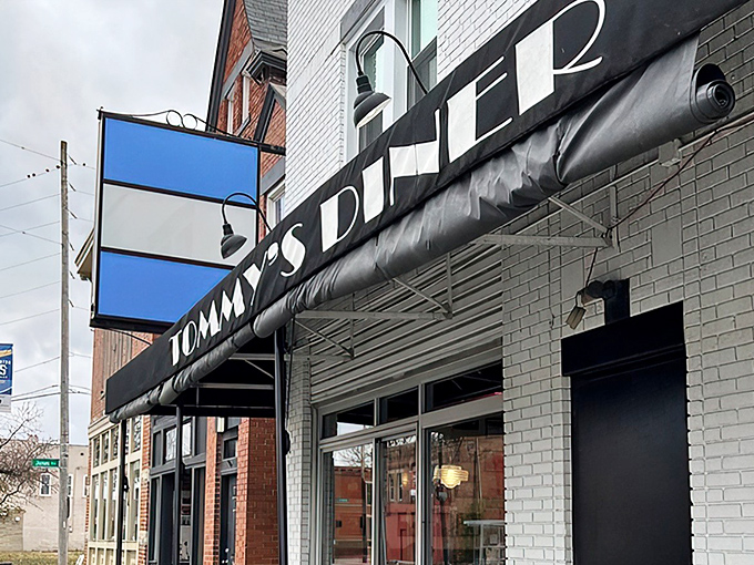 That iconic blue and black sign isn't just announcing a diner—it's promising a time machine to when calories were just numbers and comfort was king.