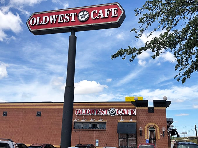 The iconic red Oldwest Cafe sign stands tall against the Texas sky, like a beacon calling hungry breakfast enthusiasts from miles around.