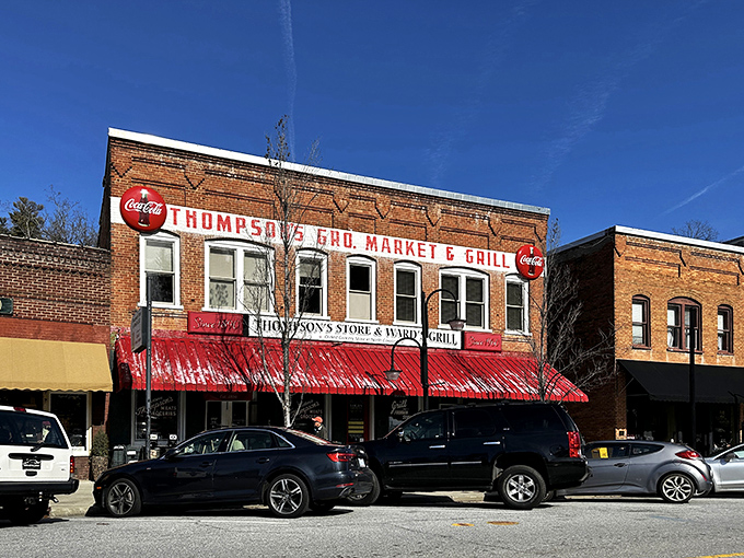 The classic brick façade of Thompson's Store & Ward's Grill stands proudly on Saluda's Main Street, its vintage Coca-Cola sign beckoning hungry travelers like a delicious mirage.
